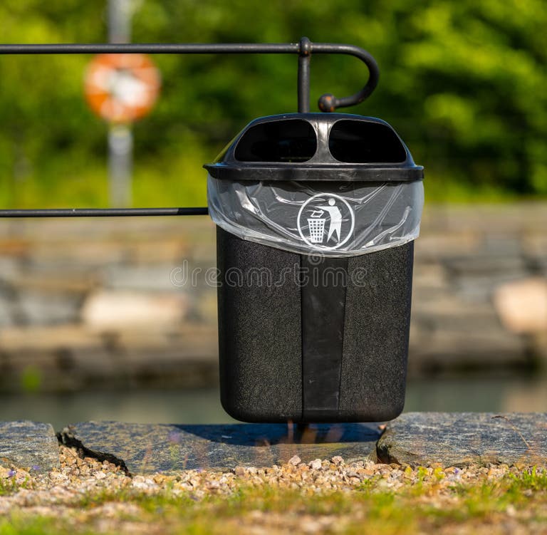 Black Trash Can by a Railing.. Stock Image - Image of building, wall ...