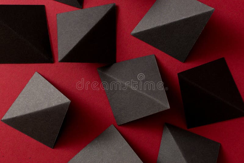 Black Triangle Shapes on Red Background, Top View Stock Photo - Image ...