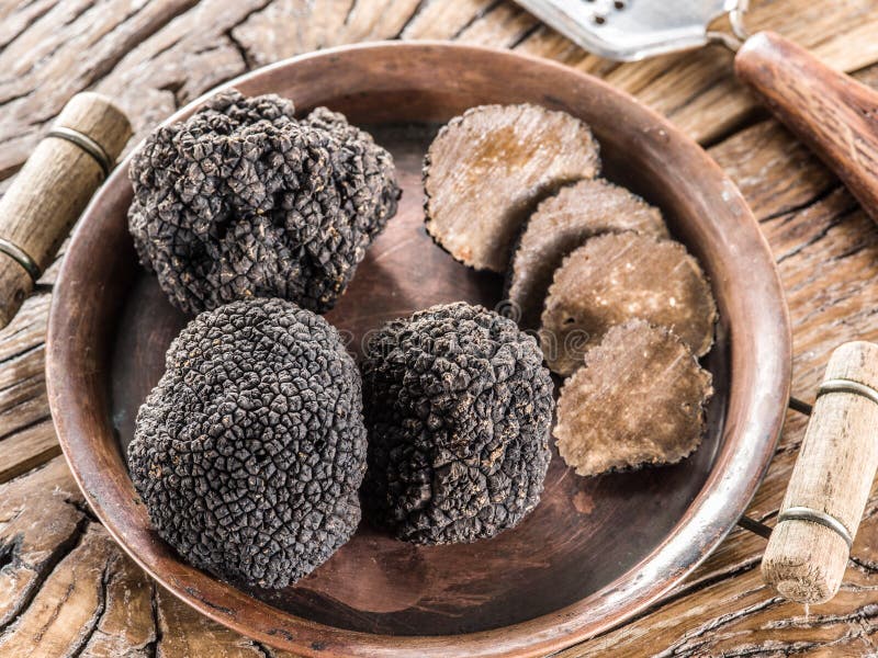 Black Truffles and Truffle Slices on a Graphite Board. Stock Image ...