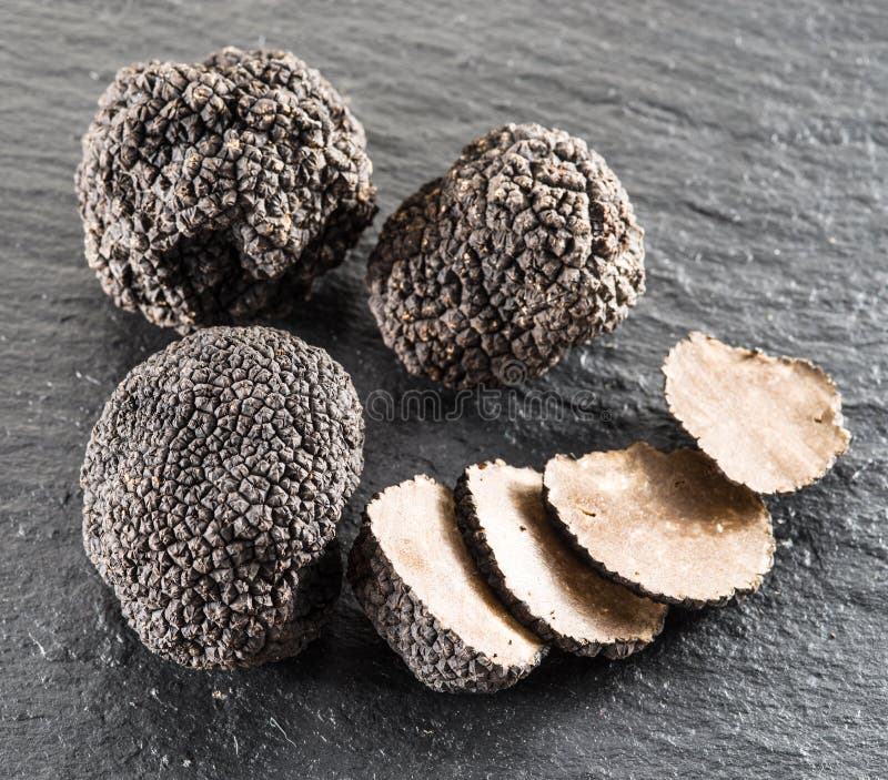 Black Truffles and Truffle Slices on a Graphite Board. Stock Image ...
