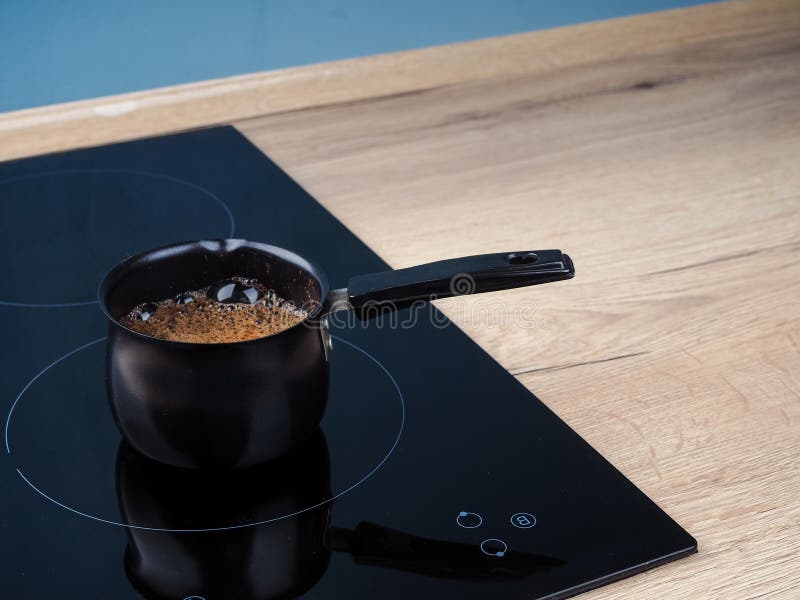 Black Turk with Coffee on the Induction Cooker Stock Image - Image of ...