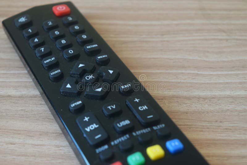 Black TV Remote Control on a Wooden Table Stock Image - Image of ...