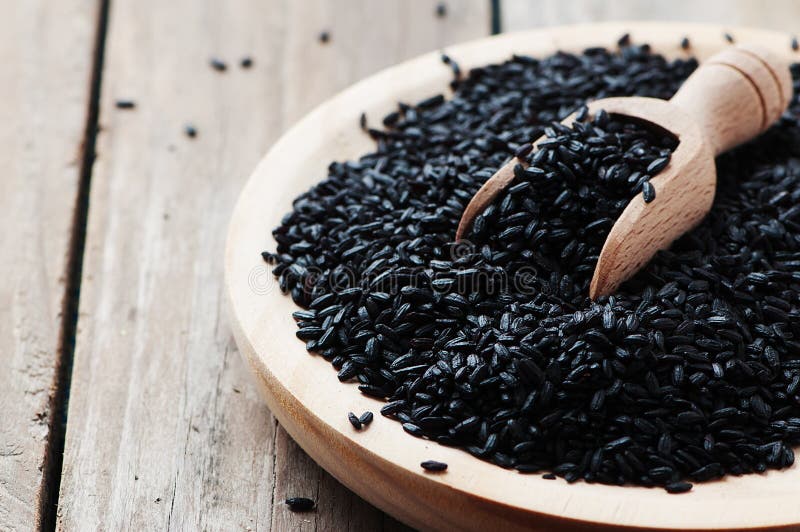 Black Uncooked Rice on the Wooden Table Stock Image - Image of cereal ...