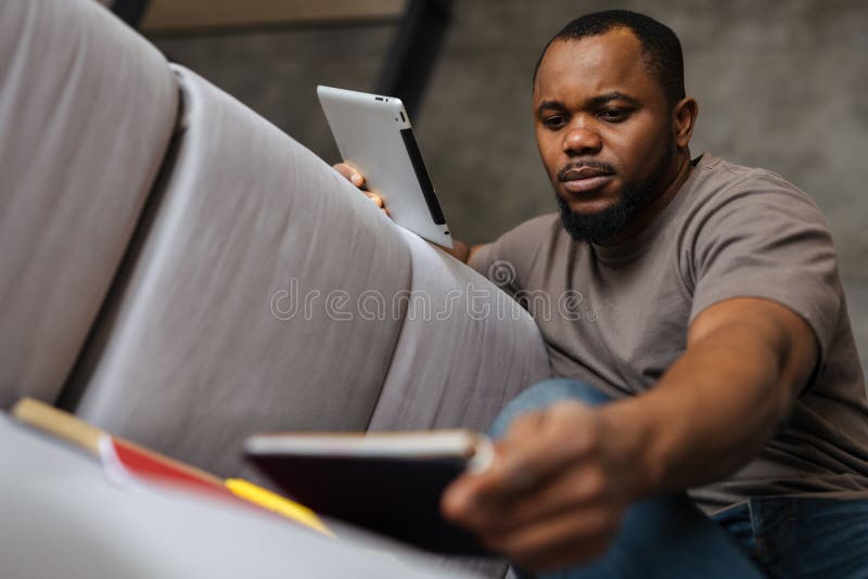 Black Unshaven Man Using Tablet Computer while Working Stock Image ...