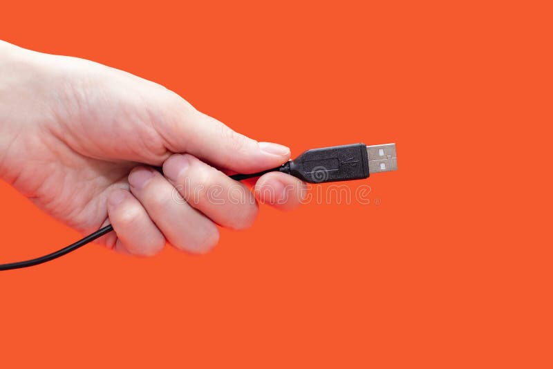Black USB Cable in Hand on an Orange Background Stock Image - Image of ...