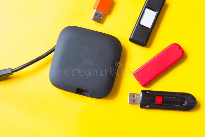 Black USB HUB with Usb Stick Flash Drives on Yellow Background. Top ...