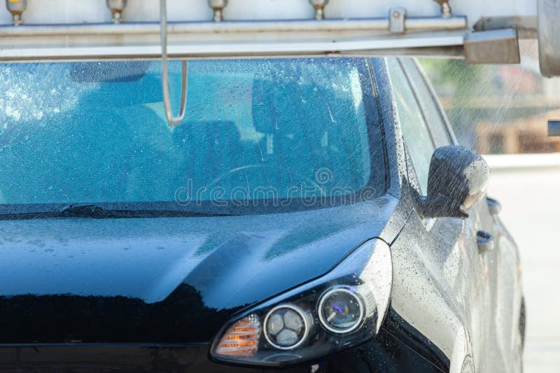 Black Vehicle is Being Washed by an Automated Car Wash System Stock ...