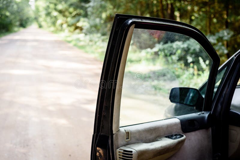 A Black Vehicle with an Open Door in Side of the Road Stock Image ...