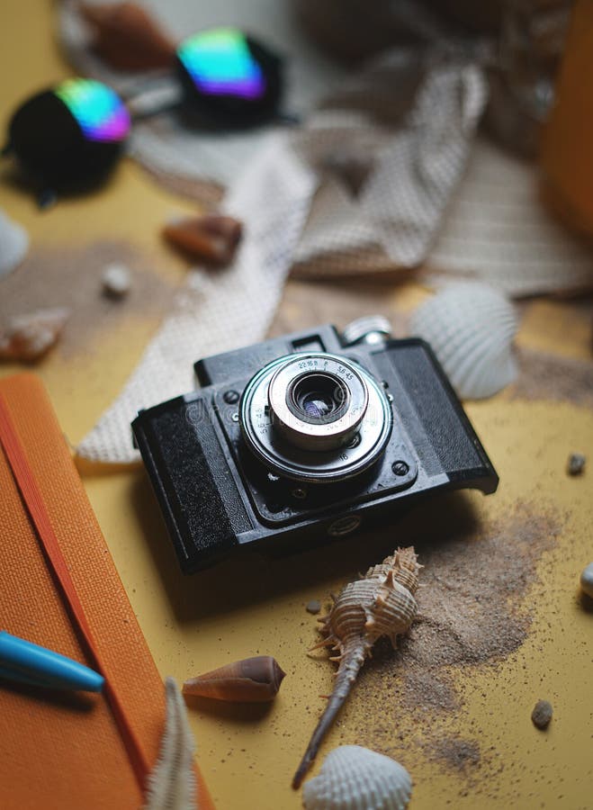 Black Vintage Camera between Summer Beach Accessories on Yellow Stock ...