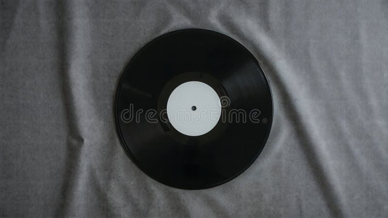 Black Vinyl Record with White Center Label on Gray Surface Stock ...