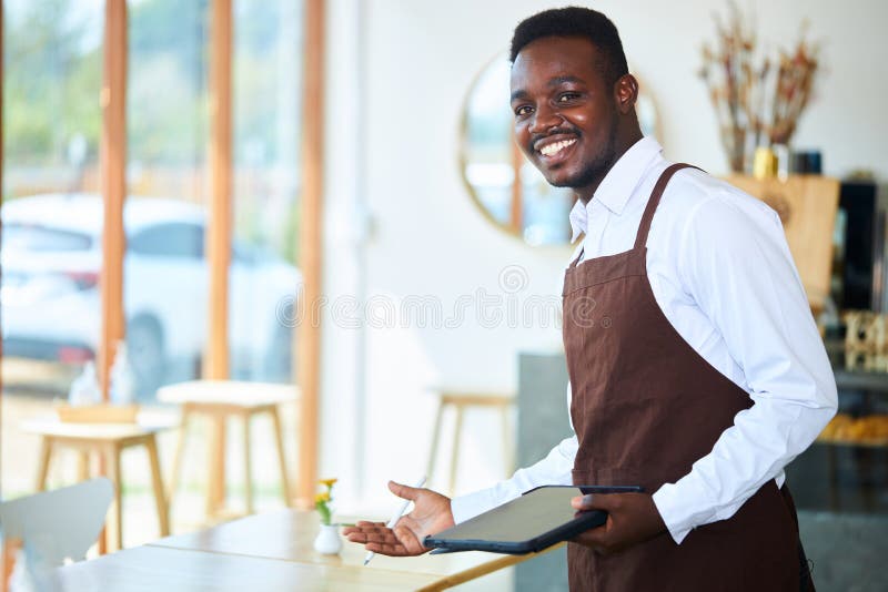 Black Waiter Serving Terrace Restaurant Guest at Table Stock Photo ...