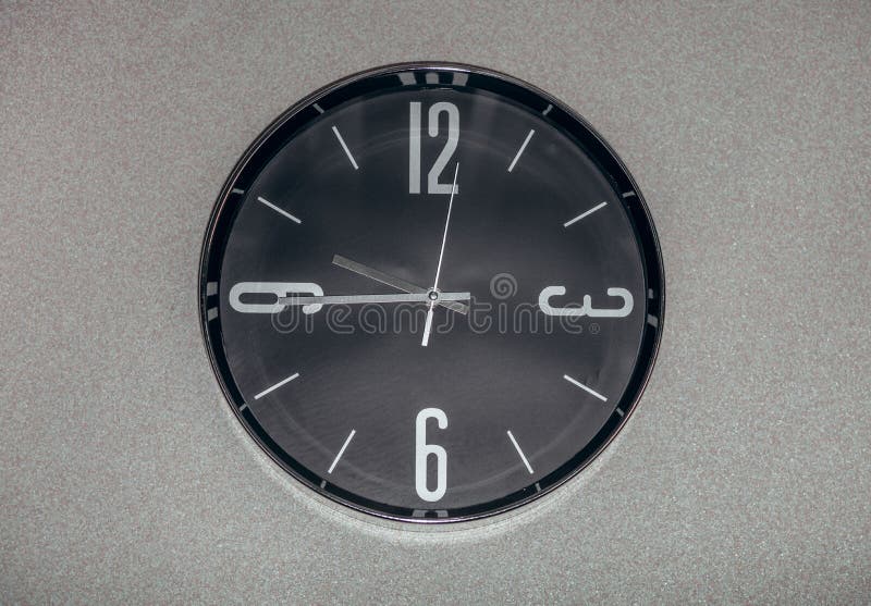 Black Wall Clock with a Second Hand Hanging on the Wall. a Minimalist ...