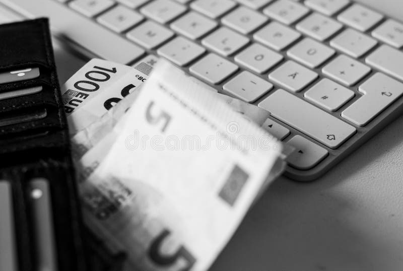 Black Wallet with Cash is Placed Atop a Laptop Computer Keyboard Stock ...