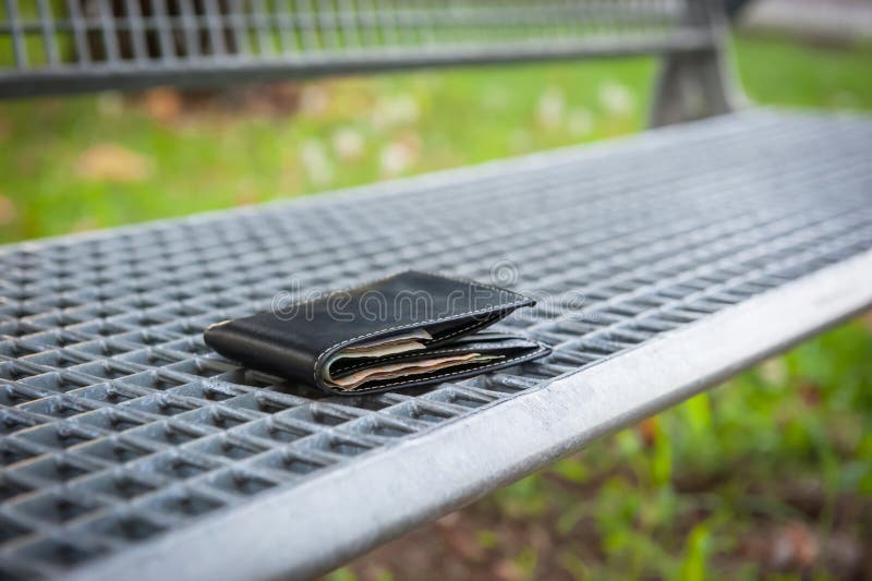 Black Wallet on Metal Bench Outdoors. Lost and Found Stock Image ...