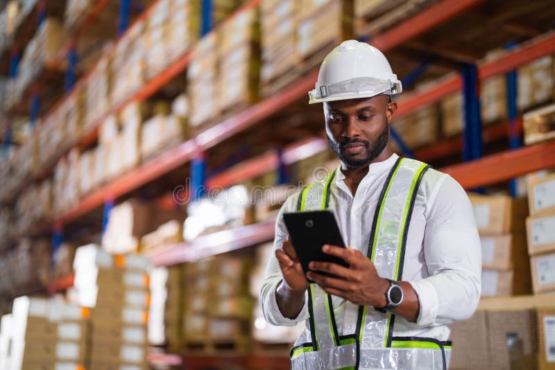 Black Warehouse Worker Checking the Delivery Status of the Package with ...