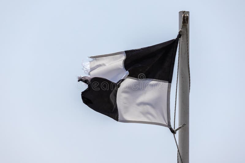 Black and White Checker Warning Beach Flag is Under Blue Sky Stock ...