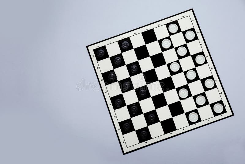 Black and White Checkerboard with Game Pieces on Light Grey Background ...
