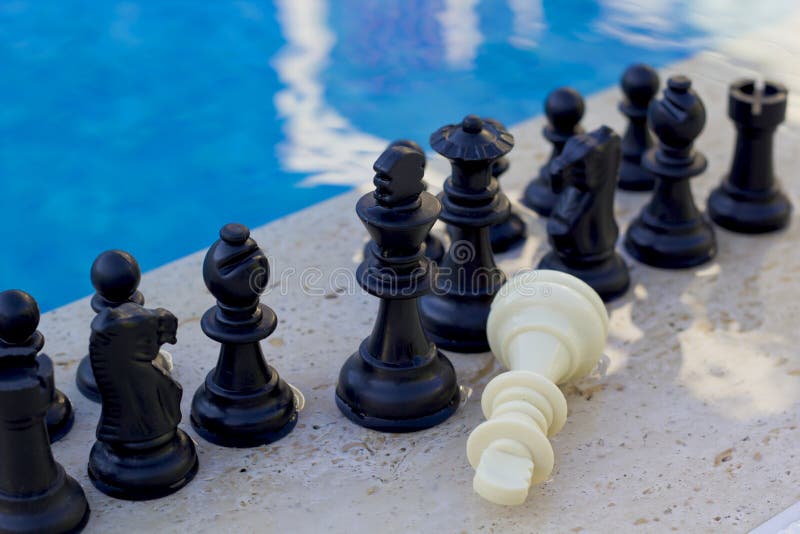 Black and White Chess Pieces at the Pool Stock Photo - Image of piece ...