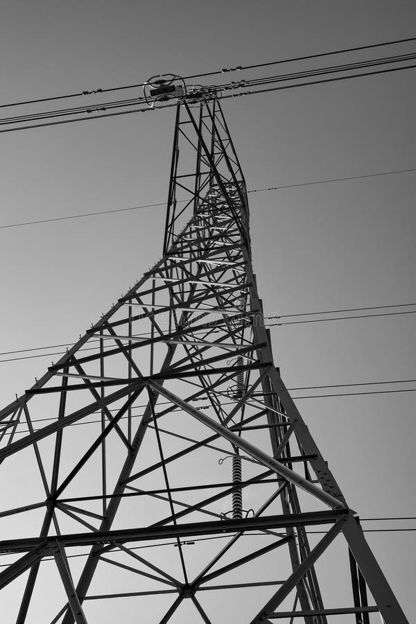 Black and White Close-up of a Towering Power Line Structure Against a ...