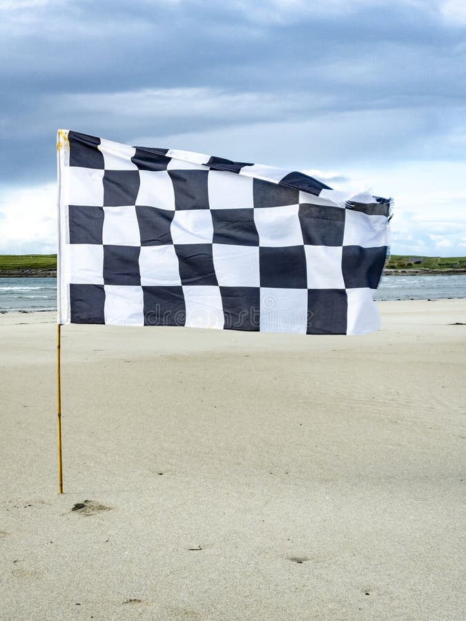 Black and White Flag Waving on the Sandy Beach Stock Image - Image of ...