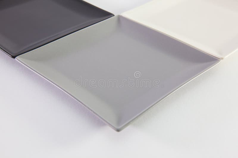 White and Gray Square Plates on the White Wooden Table Stock Image ...