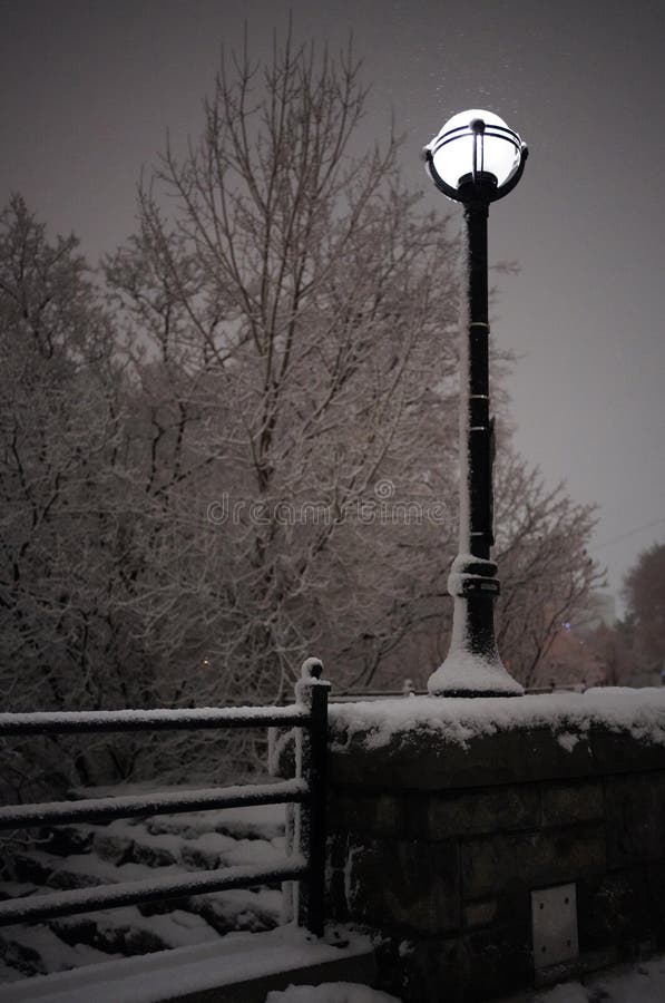 Black and White Image of Lamp Post of a Bridge Under Falling Snow Stock ...
