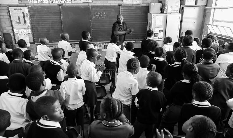 Black and White Image of a Teacher Instructing a Classroom Full of ...