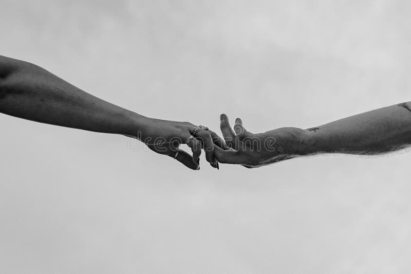 Black and White Image of Two Hands Reaching Out, Symbolizing Connection ...