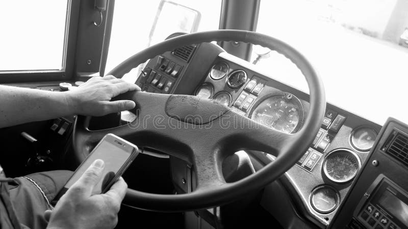 Black and White Image of Bus Driver Using Smartphone while Driving ...