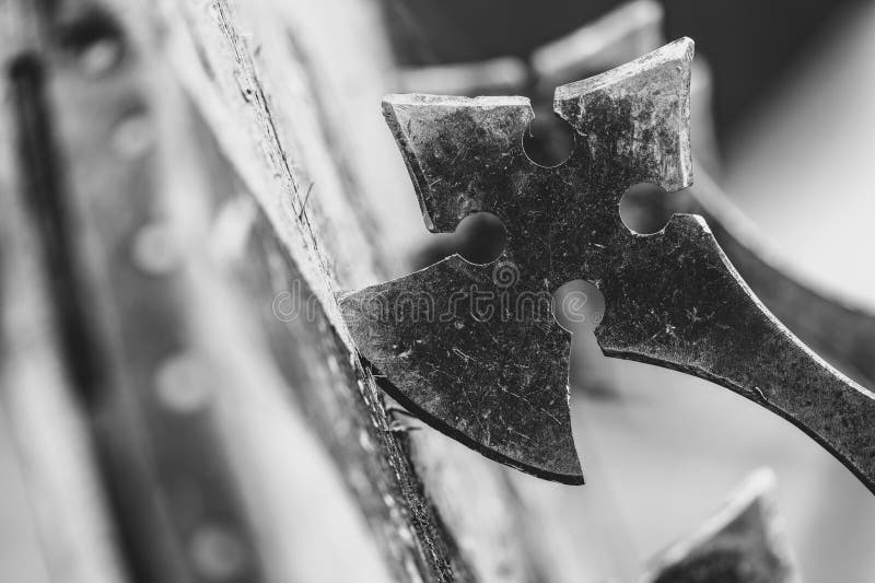A Black and White Photo of a Rusty Axe with a Cross on it Stock Image ...