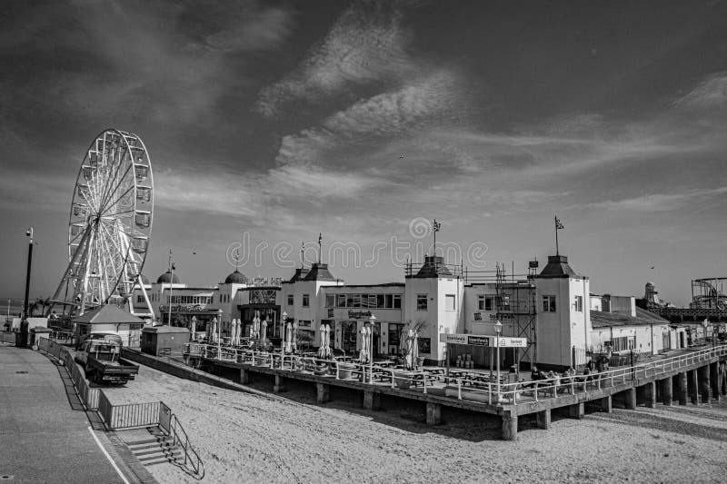 Black-and-white Photograph of a Seaside Pier Featuring a Ferris Wheel ... Black-and-white Photograph of a Seaside Pier Featuring a Ferris Wheel ...
