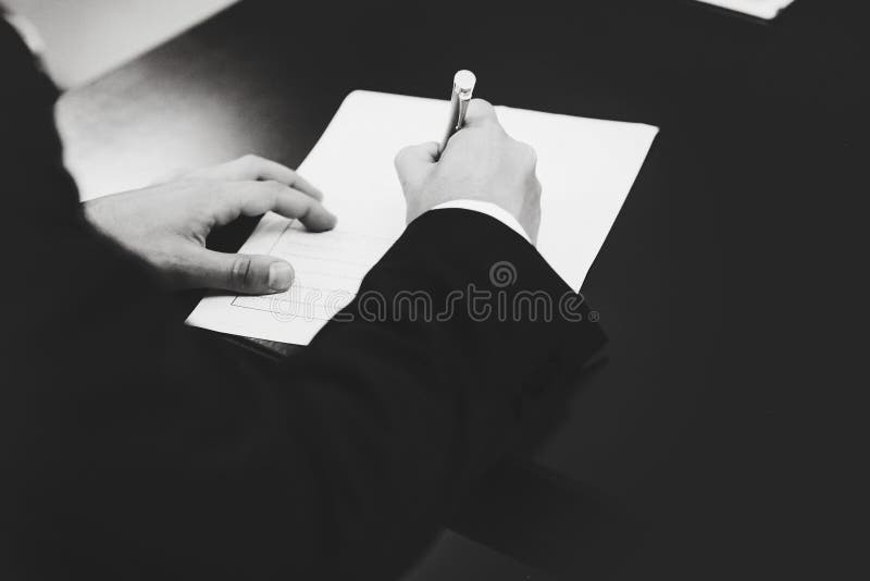 A Black and White Picture of a Man Signing Papers Stock Image - Image ...