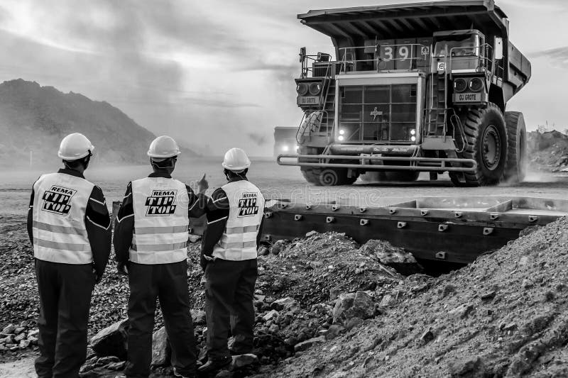 Black and White Shot of Construction Workers Observing a Large Mining ...