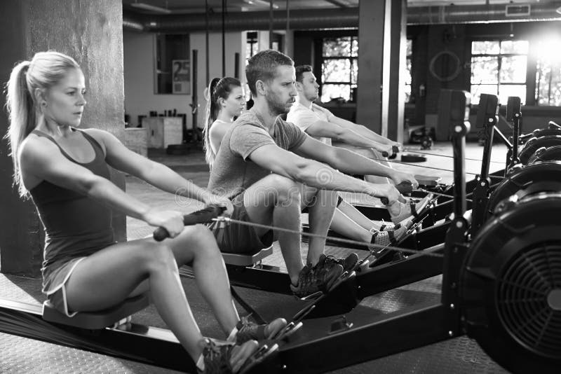 Black and White Shot of Gym Class Using Rowing Machines Stock Image ...