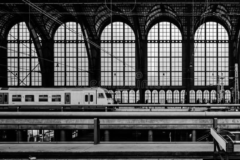 Black and White Shot of a Train Station with Large Arched Windows and a ...