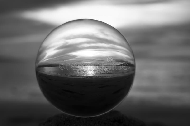Black and White Sunset Light Glowing Over Ocean Captured in Ball Stock ...
