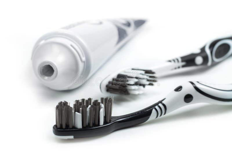 A Black and White Toothbrush with Toothpaste on White Background with ...