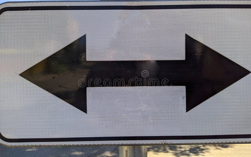 Black and White Traffic Sign with Arrows Pointing To the Left and To ... Black and White Traffic Sign with Arrows Pointing To the Left and To ...
