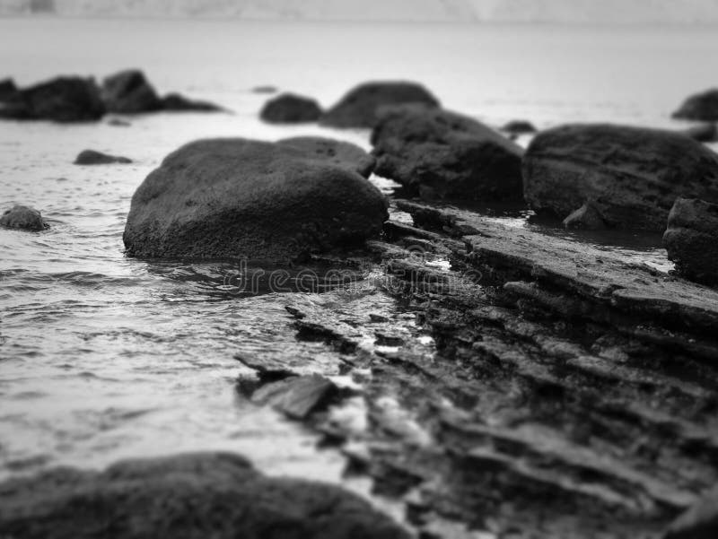 Black and White View of Ocean Rocks on a Beach Stock Image - Image of ...