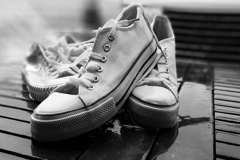 Black and white wet shoes stock photo. Image of damage - 189571690