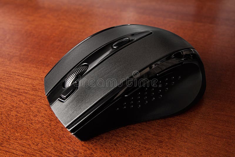 Black Wireless Computer Mouse on a Brown Wooden Table Stock Photo ...