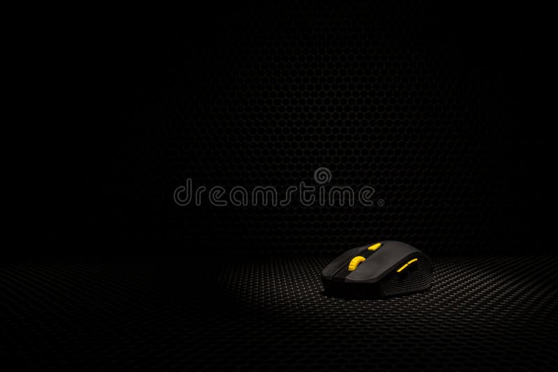 A Black Wireless Computer Mouse with Yellow Buttons is Selectively ...