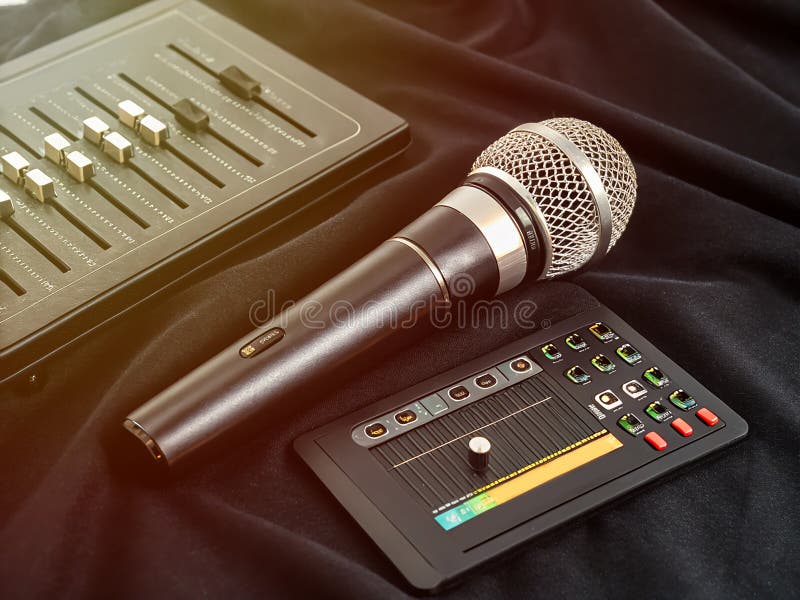 Black Wireless Microphone and Sound Equalizer Placed on a Black Cloth ...