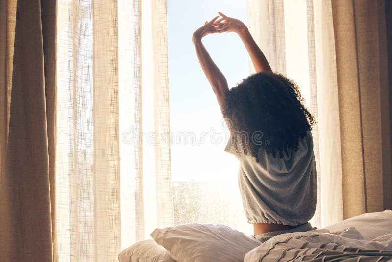 Black Woman Back Stretching And Waking Up In Home Bedroom After