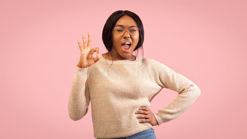 Black Woman Gesturing Okay Winking at Camera, Pink Background, Panorama ... Black Woman Gesturing Okay Winking at Camera, Pink Background, Panorama ...