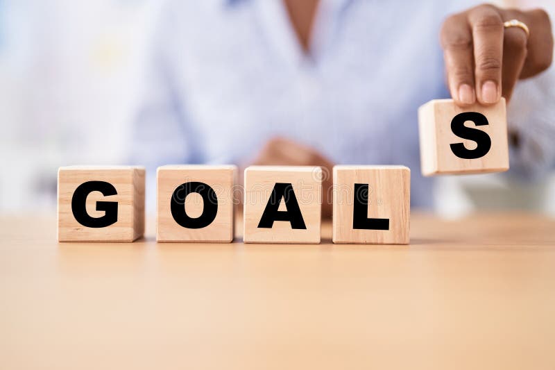 Black Woman Holding Cubes with Goals Word on the Table Stock Photo ...