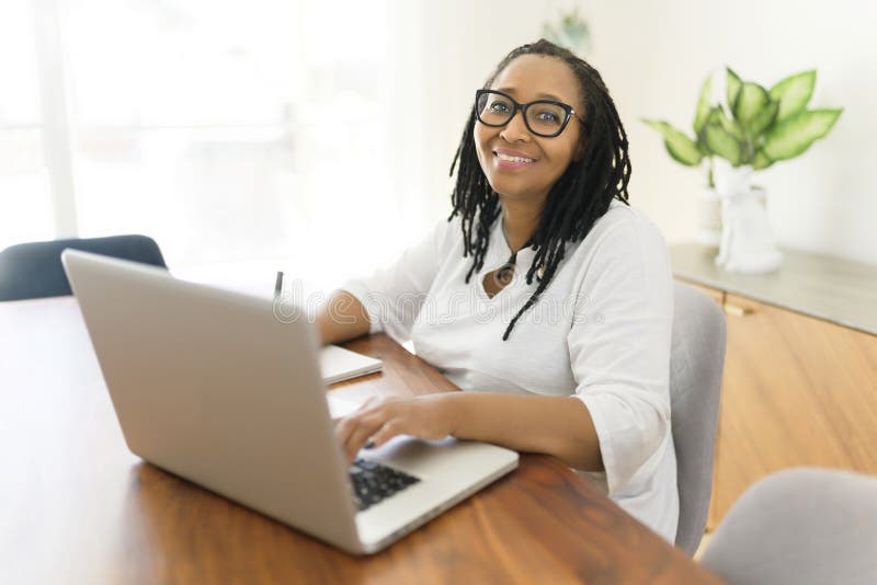 Black Woman Using Computer in Modern Kitchen Interior Stock Image ...