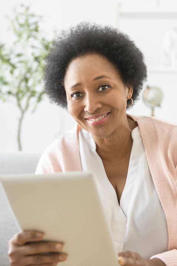 Black Woman Using Tablet on Living Room at Home Stock Photo - Image of ...