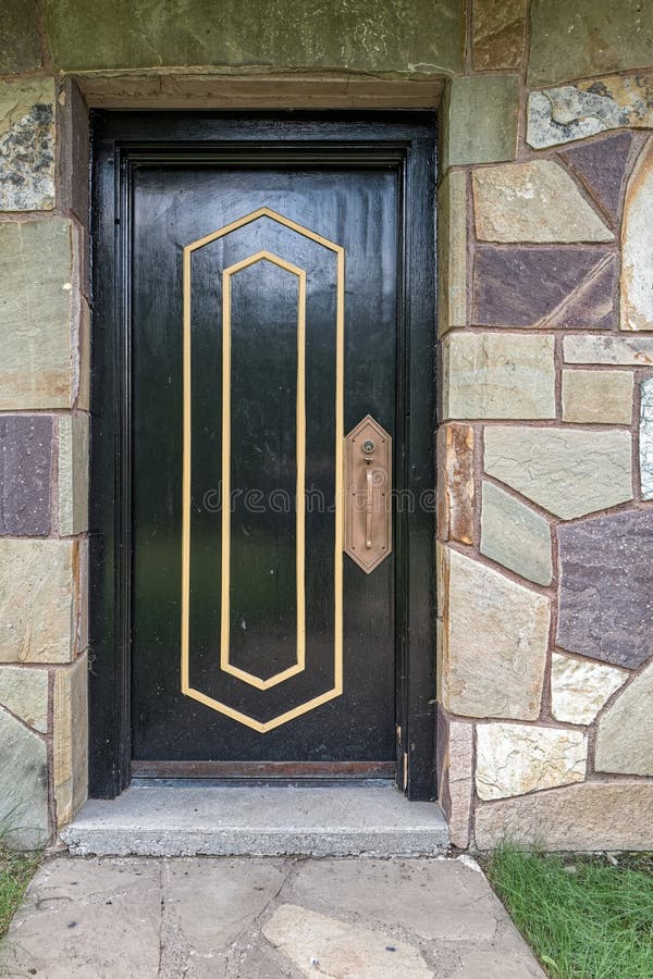 A Black Wood Door on the Side of a Stone Building Stock Image - Image ...