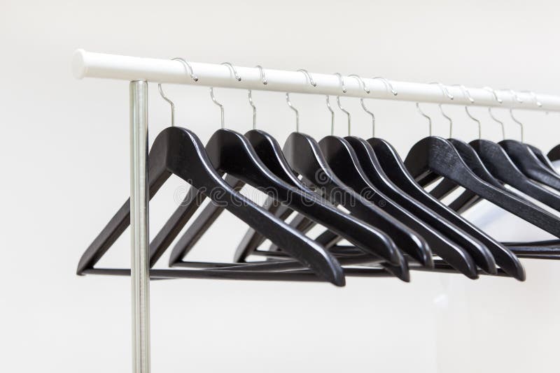 Black Wooden Hangers Hanging on Rack Rail Stock Photo - Image of ...